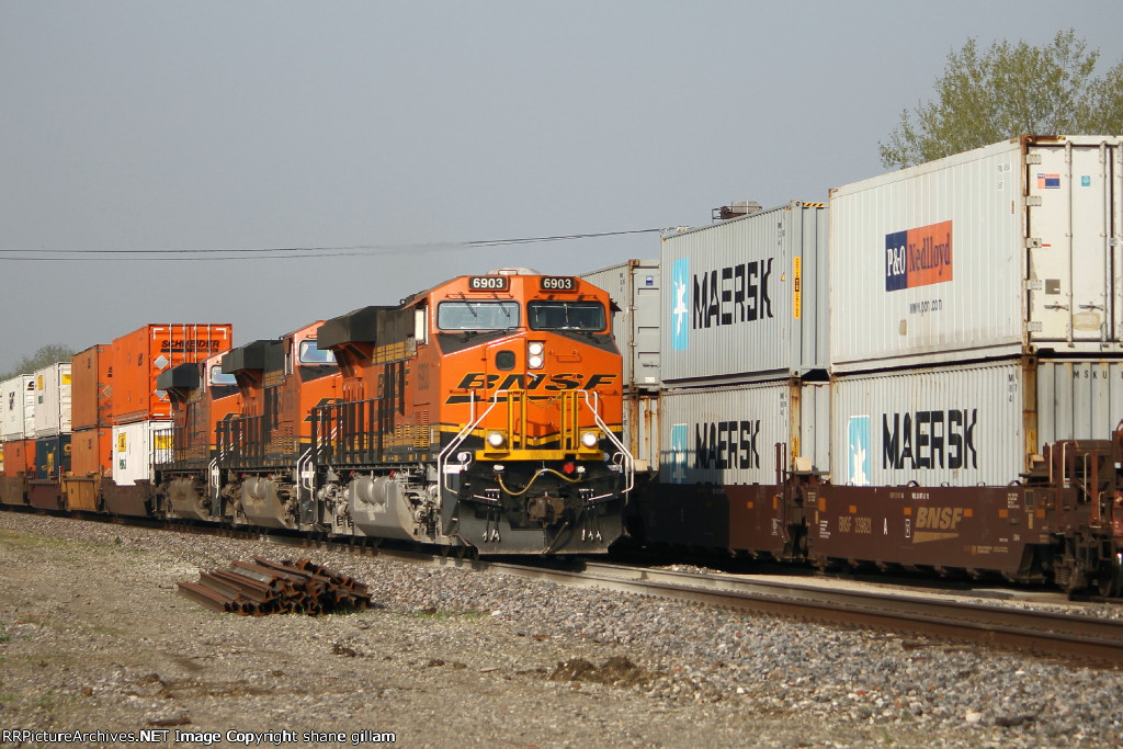 BNSF 6903 meets a wb stack train at the amtrak station.